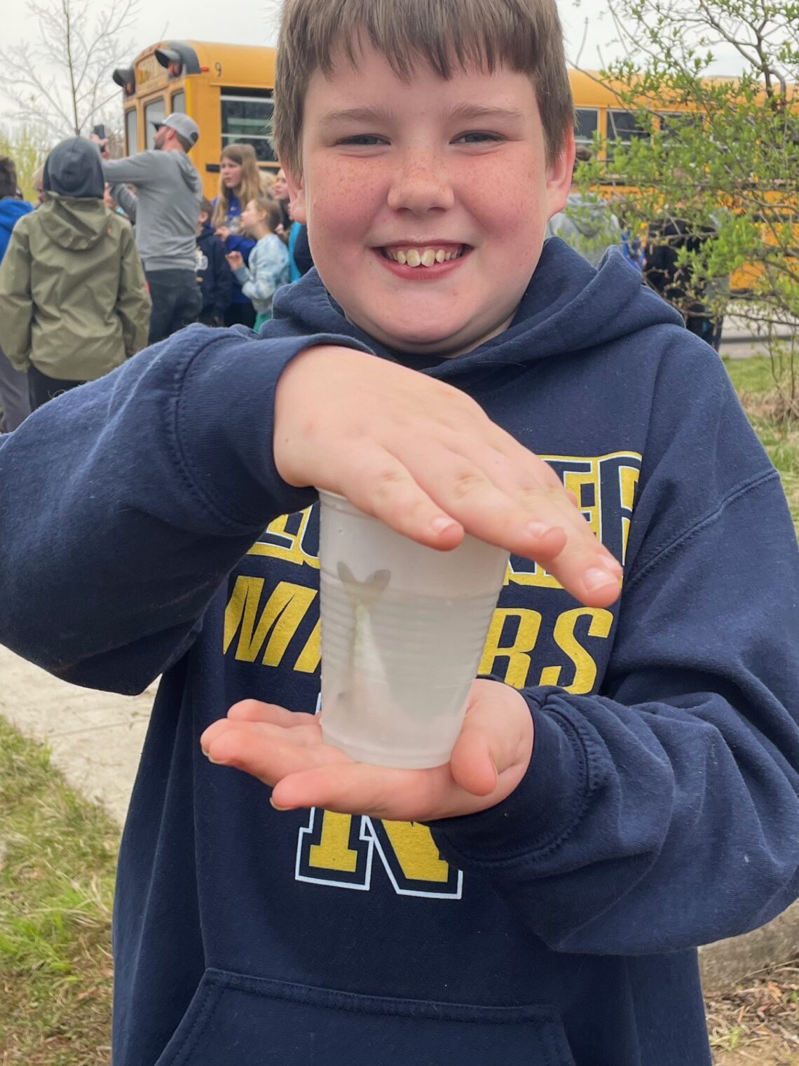 Negaunee Middle School students release Chinook salmon fry into Dead River